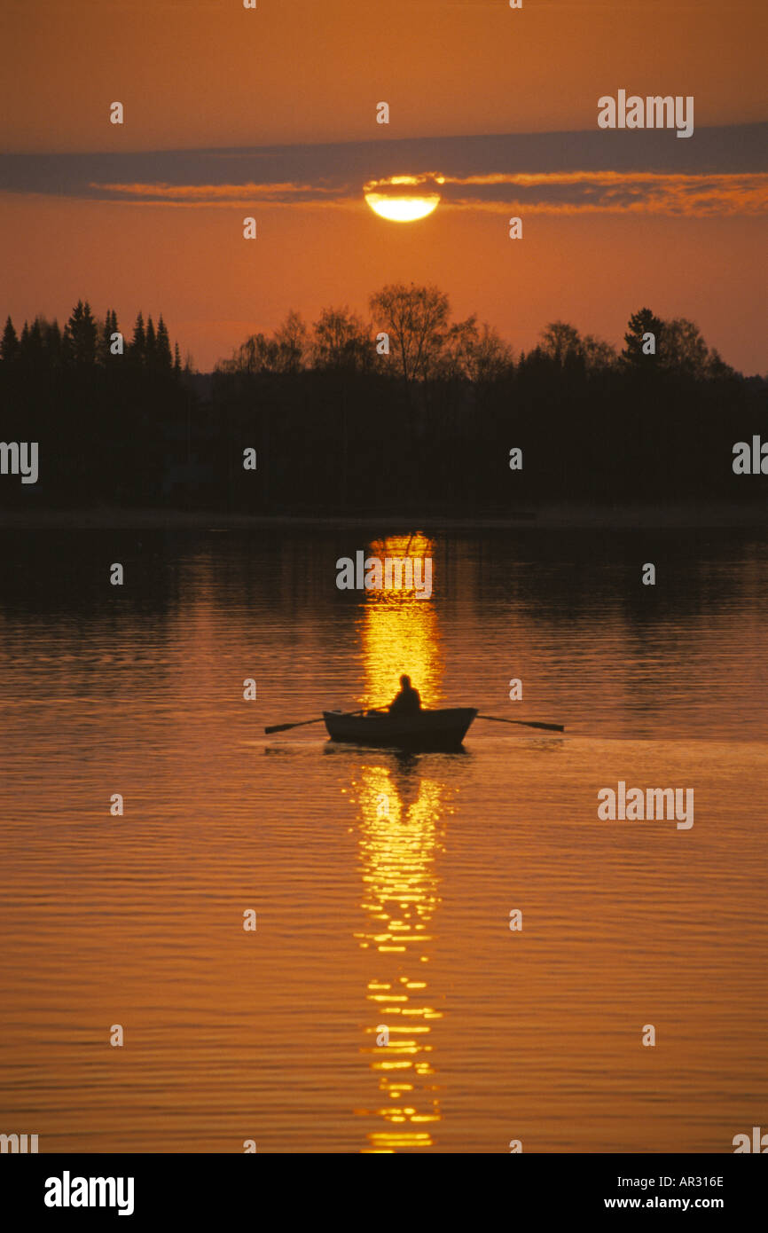 Sunset with boat Stock Photo - Alamy