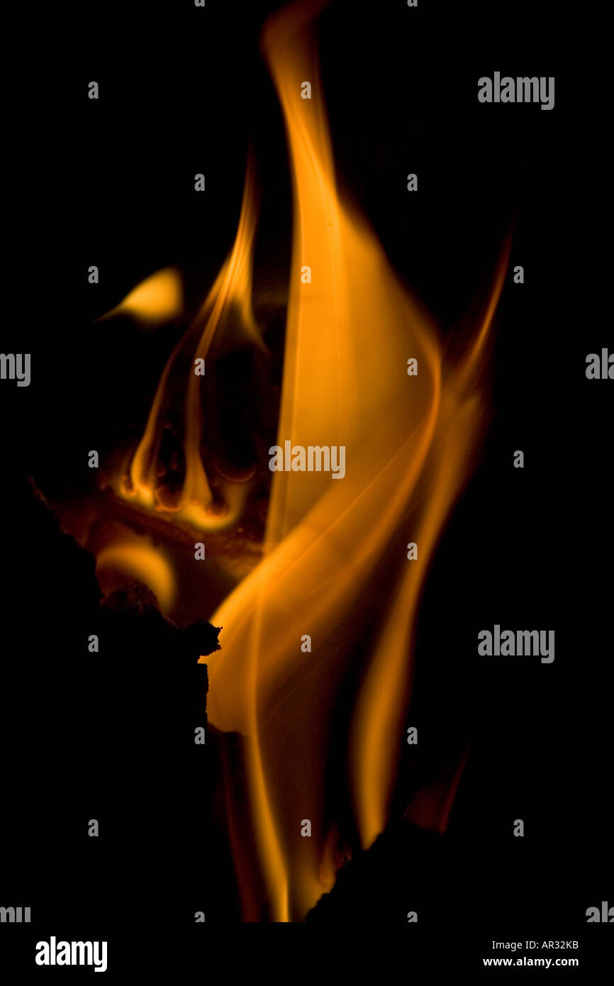 Flame above open fire on dark background Stock Photo - Alamy