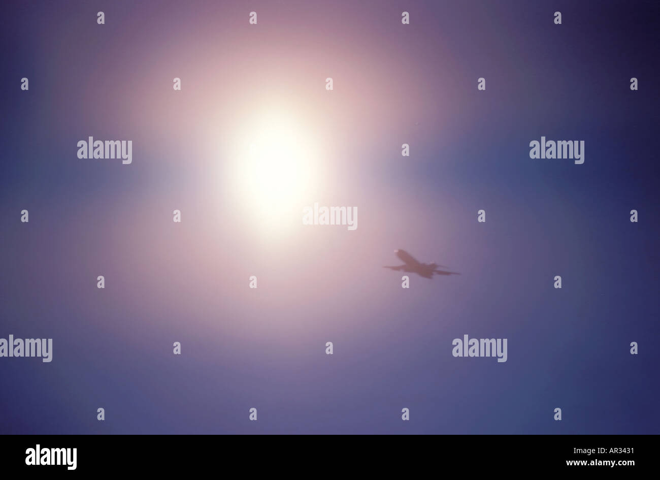 Plain flying to the sun Stock Photo - Alamy