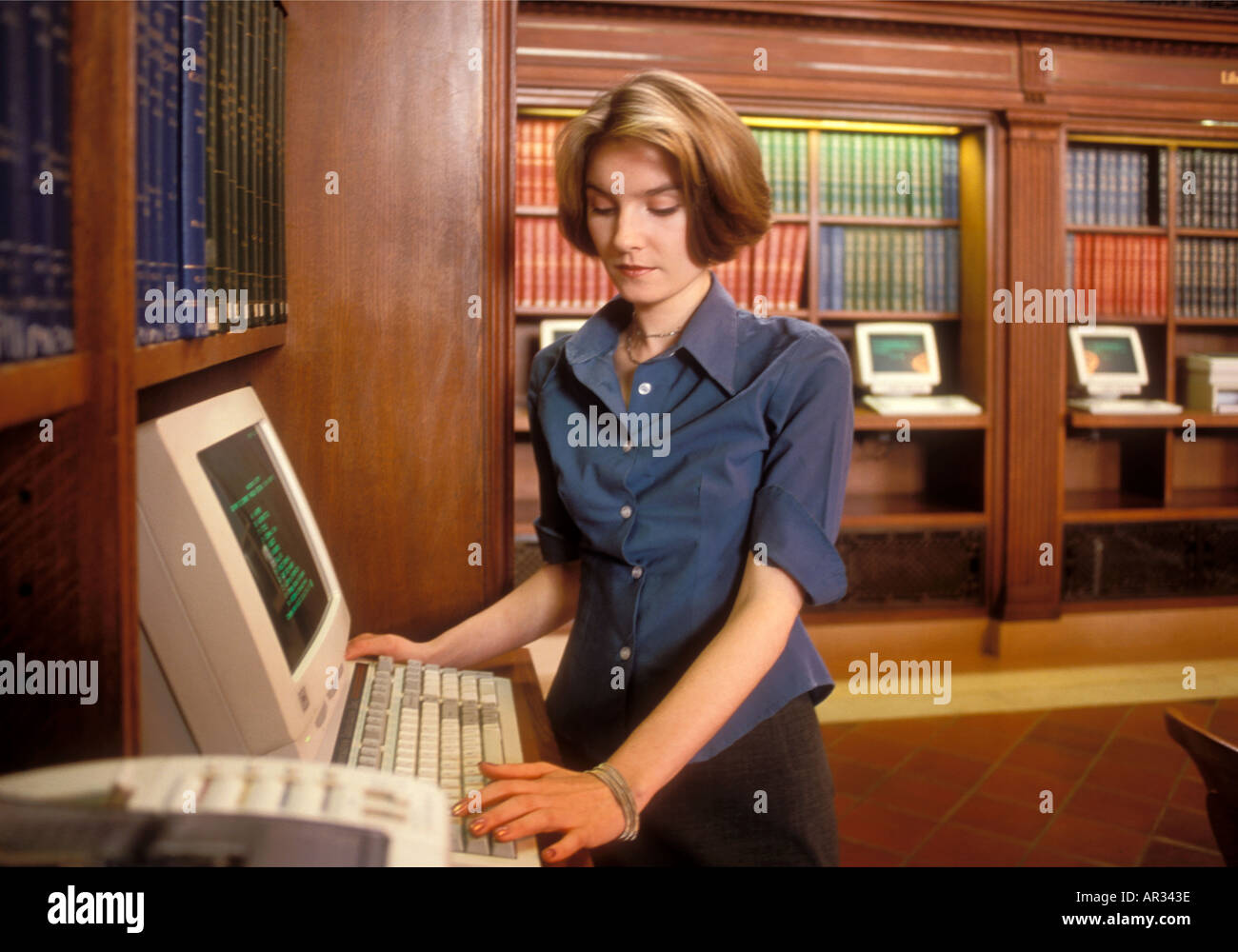 Public Library Woman by a computer Stock Photo - Alamy