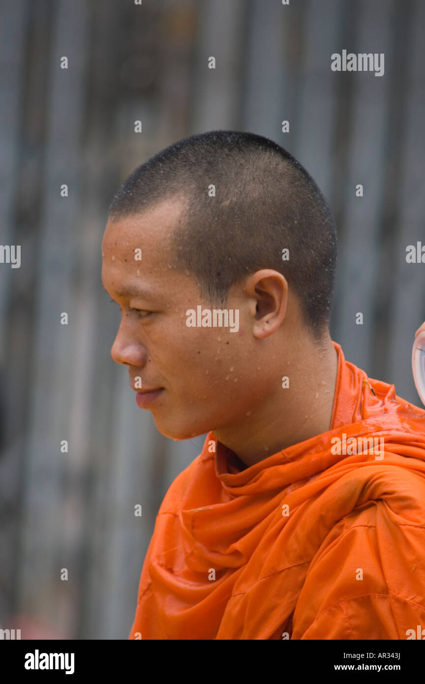 Monk soaked with water during the Pi Mai parade on Sisavangvong Road ...