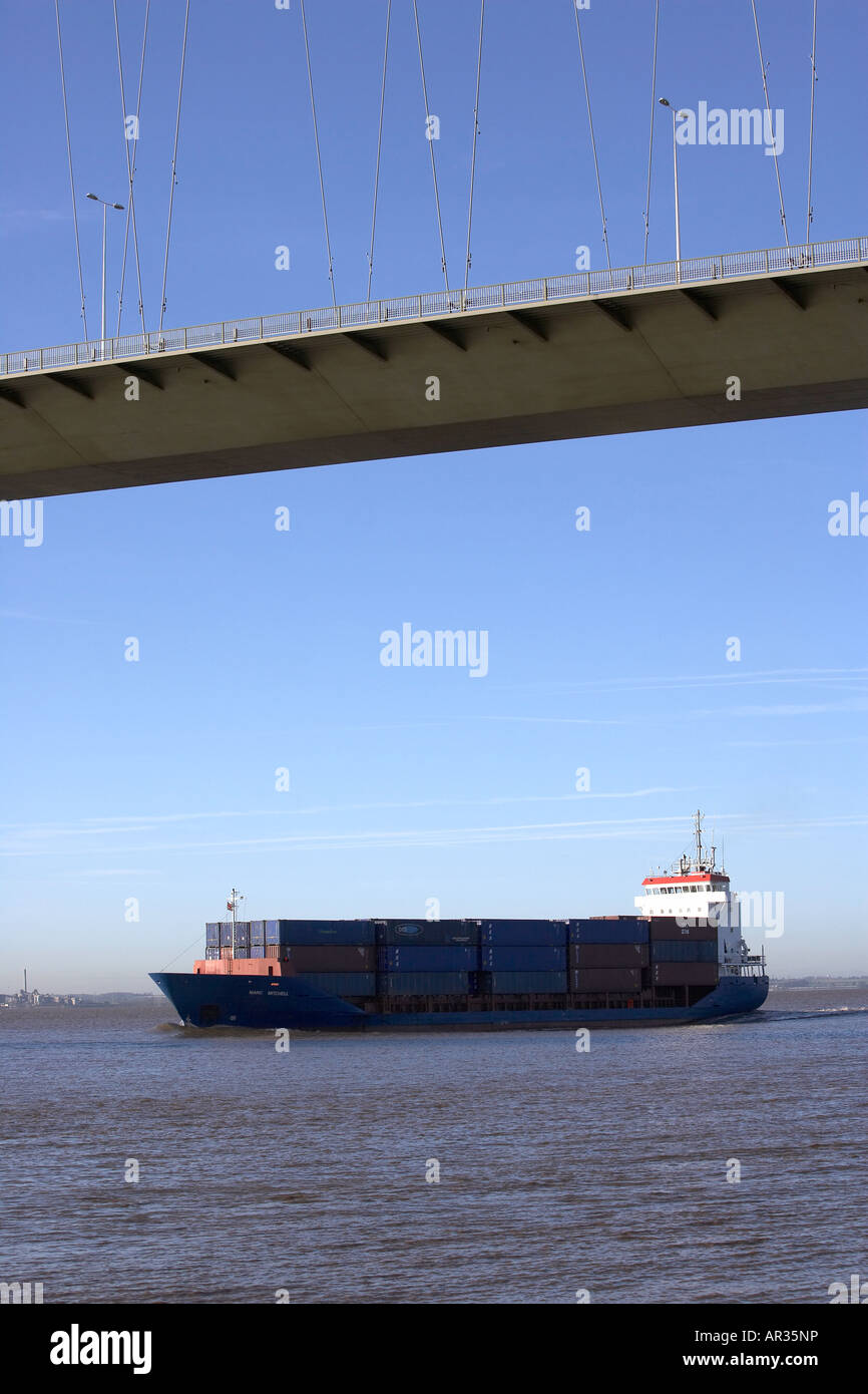 Container cargo ship sailing under the Humber Bridge on the River ...
