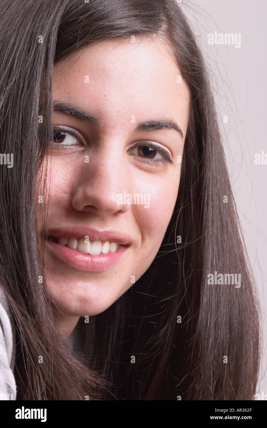 Headshot of young black haired woman looking at the camera over her ...