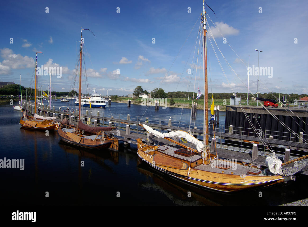 three historic wooden sailing ships moored by the lock on the Walcheren ...