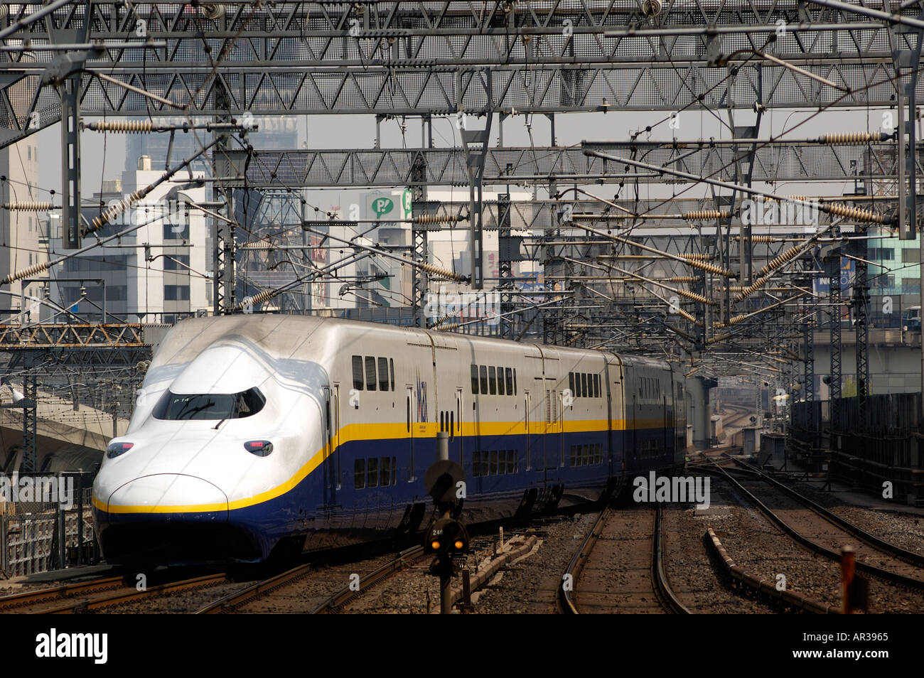 A double deck MAX shinkansen railway train approaches Tokyo station ...