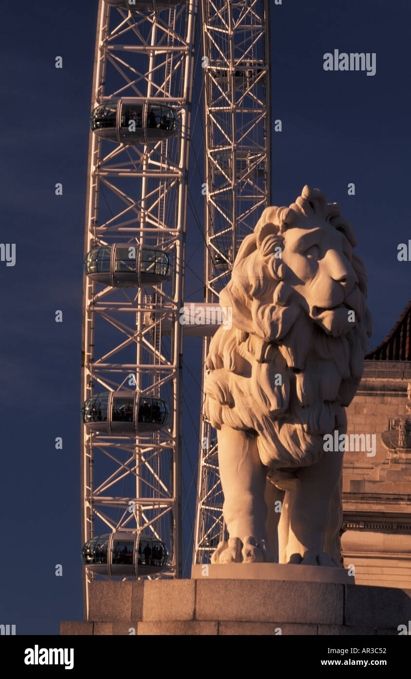 Carved stone lion on Westminster bridge with London Eye London England ...