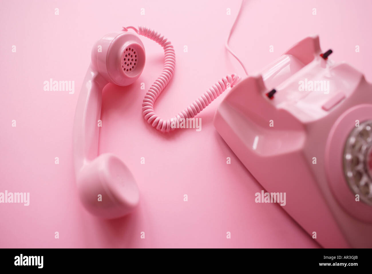 Pink telephone receiver and telephone on pink background Stock Photo ...