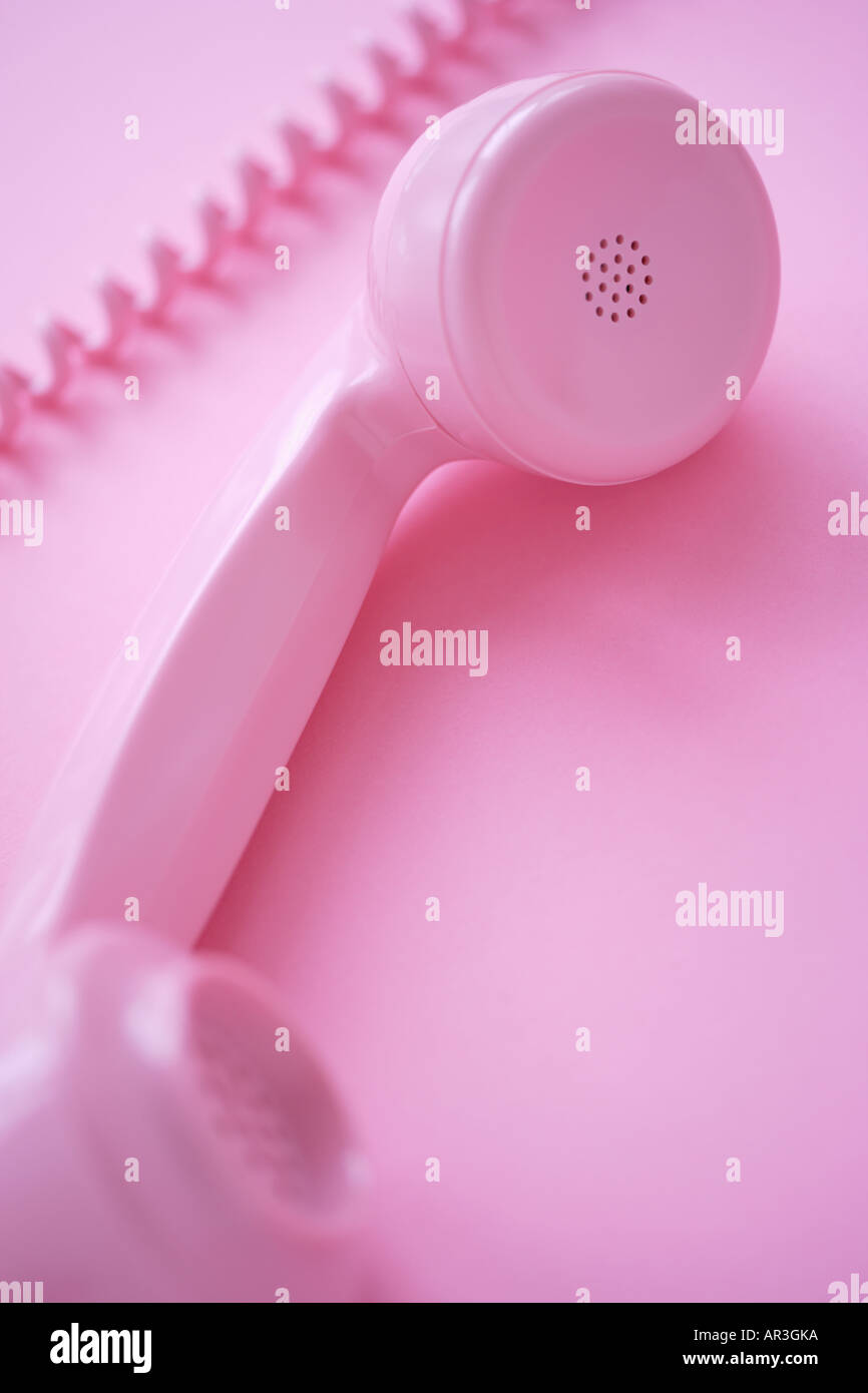 Pink telephone receiver on pink background Stock Photo - Alamy
