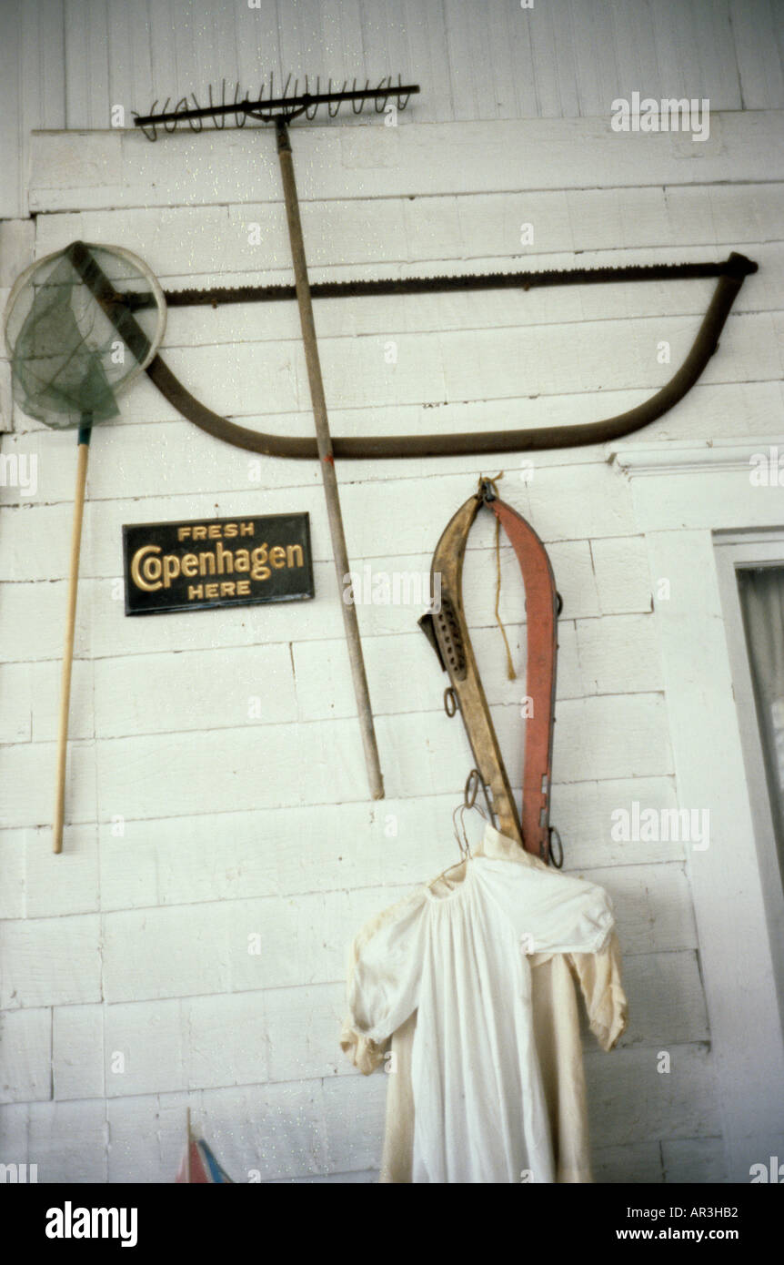 Antique items hanging on house wall Stock Photo - Alamy