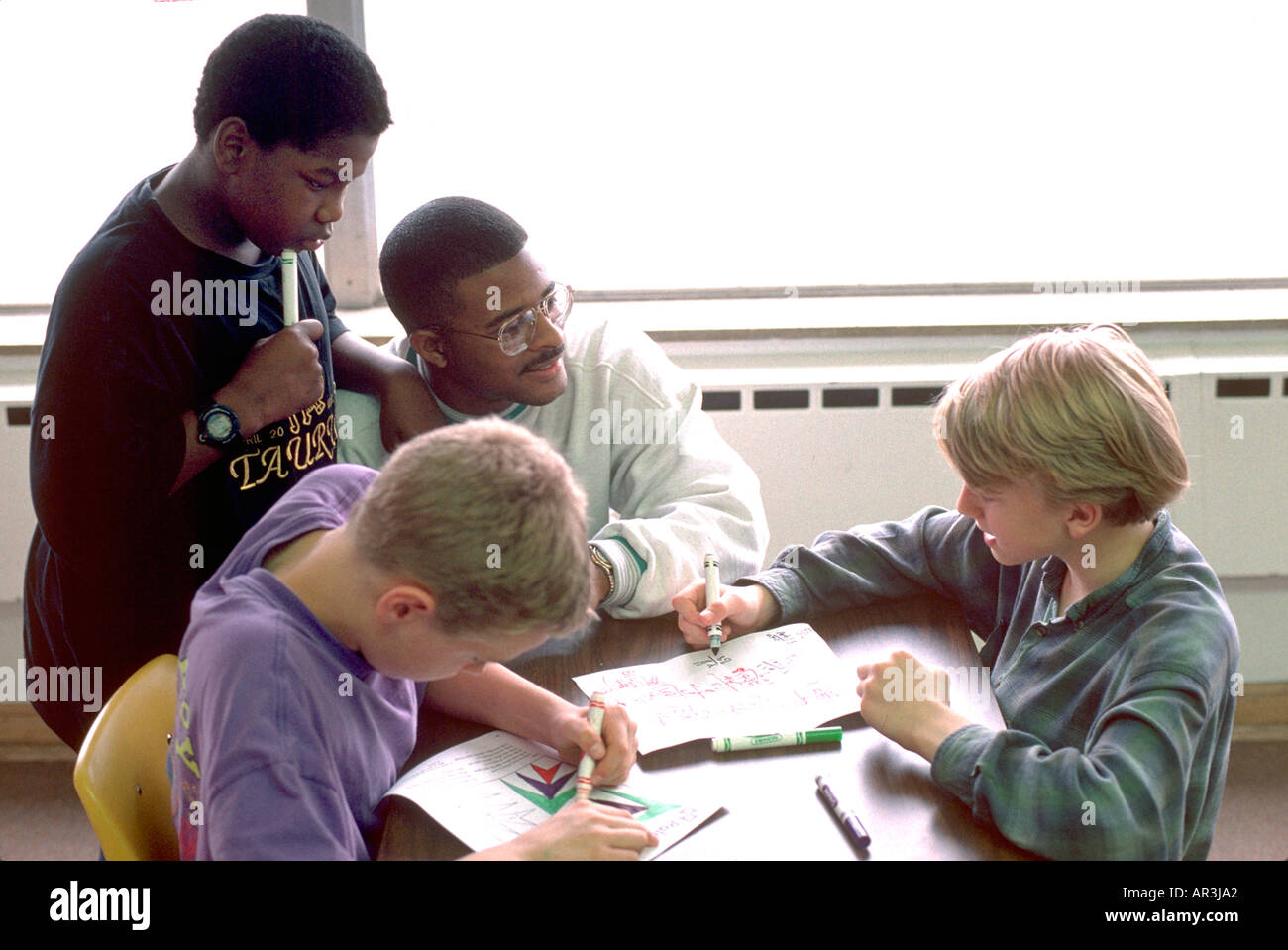 Tutor and youths age 22 and 13 in community after school study program ...