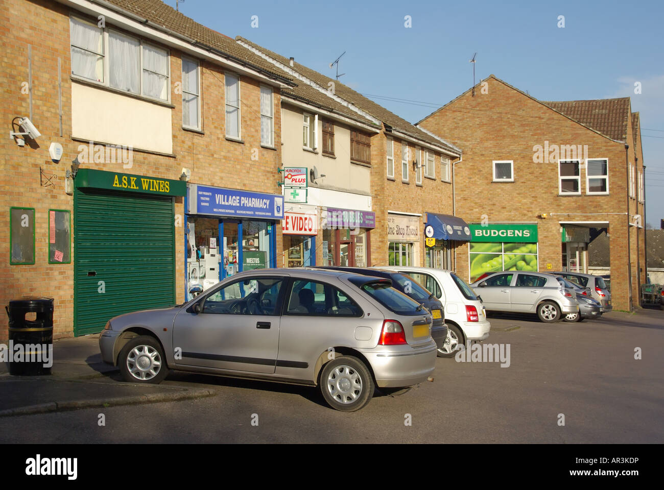 Village shops and parked cars with first floor living accommodation ...