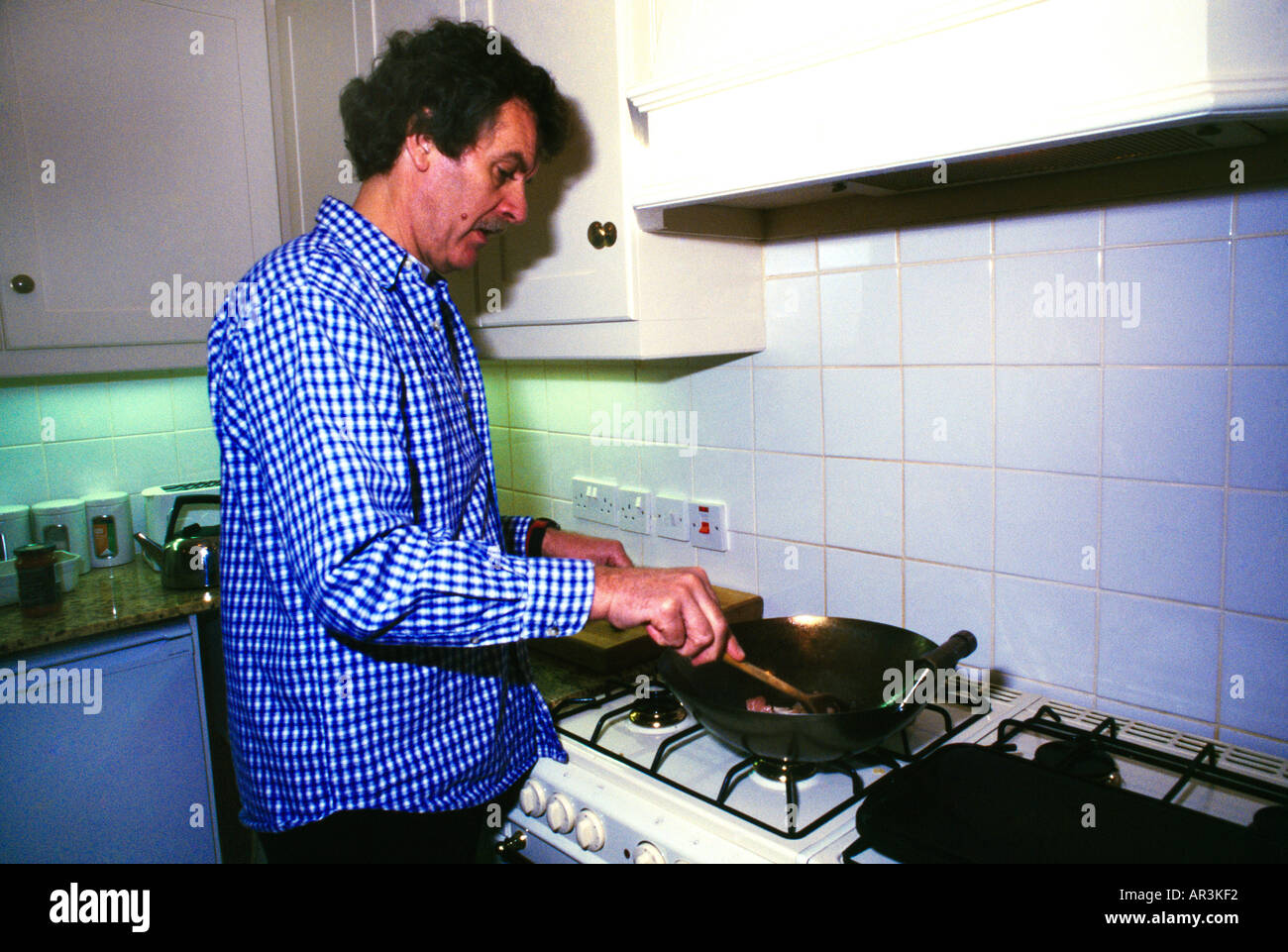Man Cooking in a Wok Stock Photo - Alamy