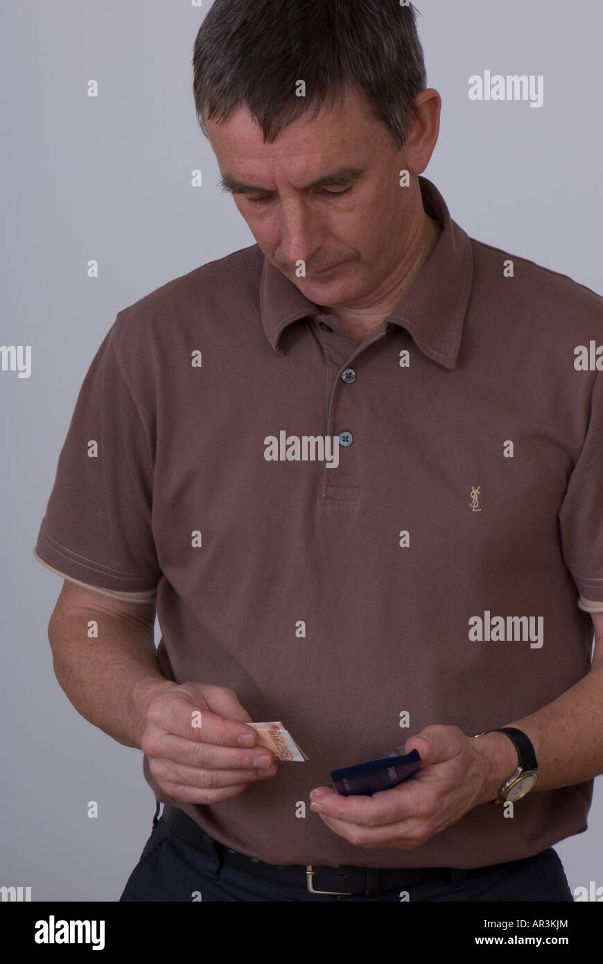 man standing pulling out wallet to pay for item Stock Photo - Alamy
