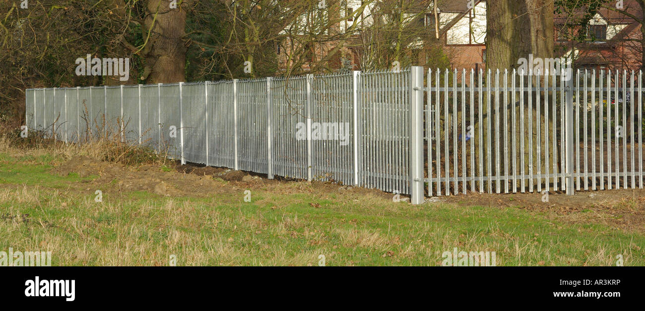 Galvanised steel palisade fence panels around paddock Stock Photo - Alamy