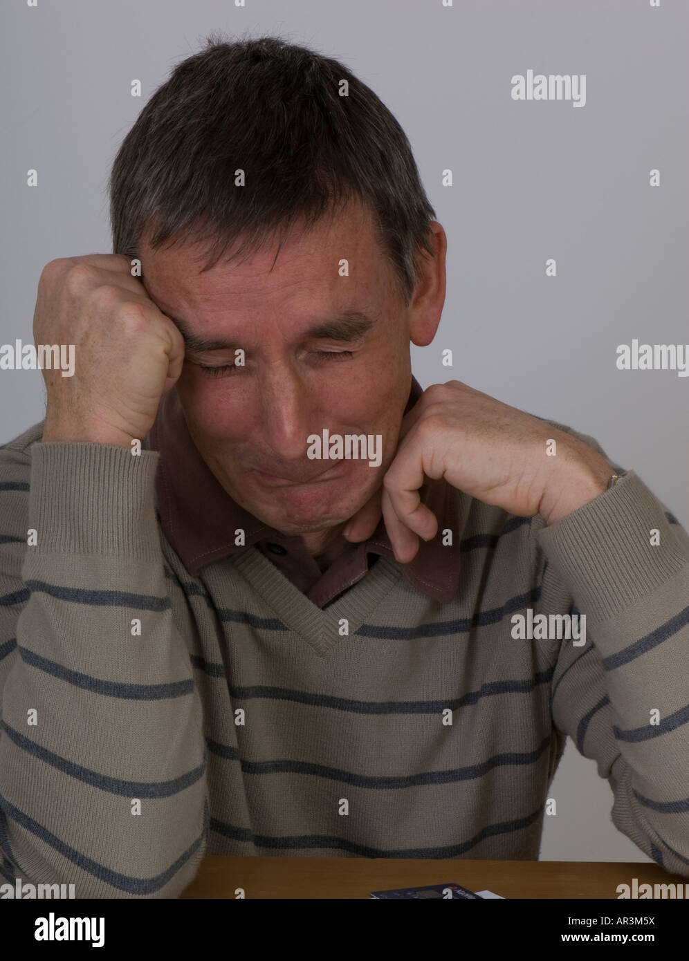 man crying over debt problems Stock Photo - Alamy