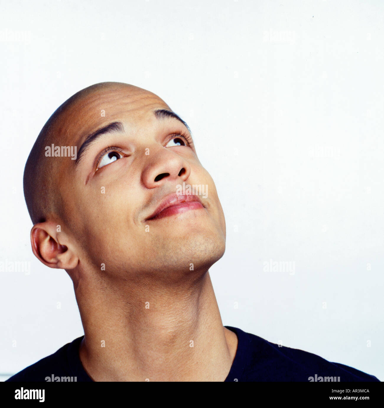 portrait of young coulered man looking up close up head face white ...