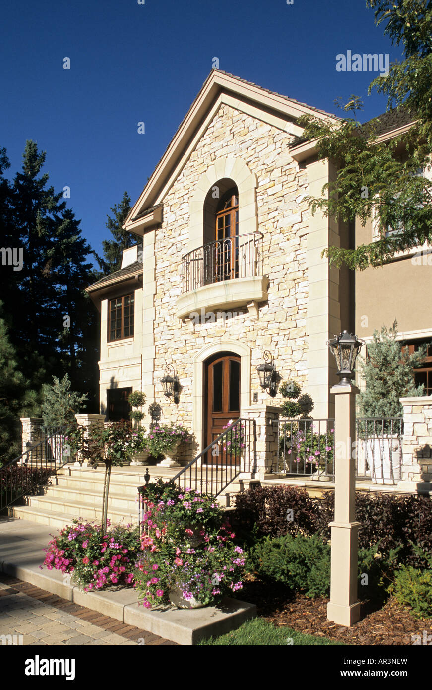 FRONT ENTRANCE OF UPSCALE MINNESOTA HOME. CONTAINER GARDEN WITH WAVE ...