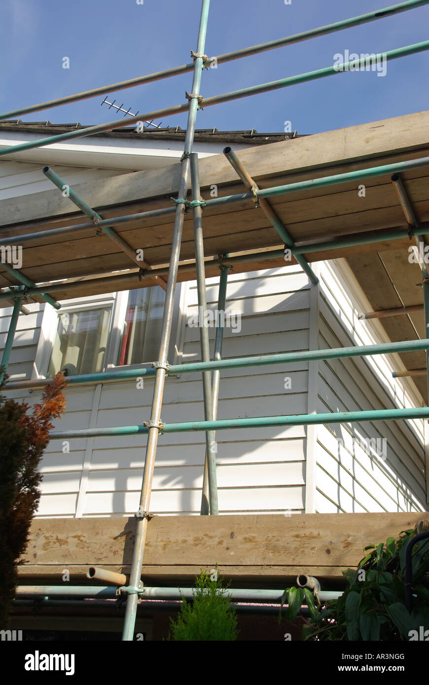 Scaffold erected around detached house for access to roof repair work ...