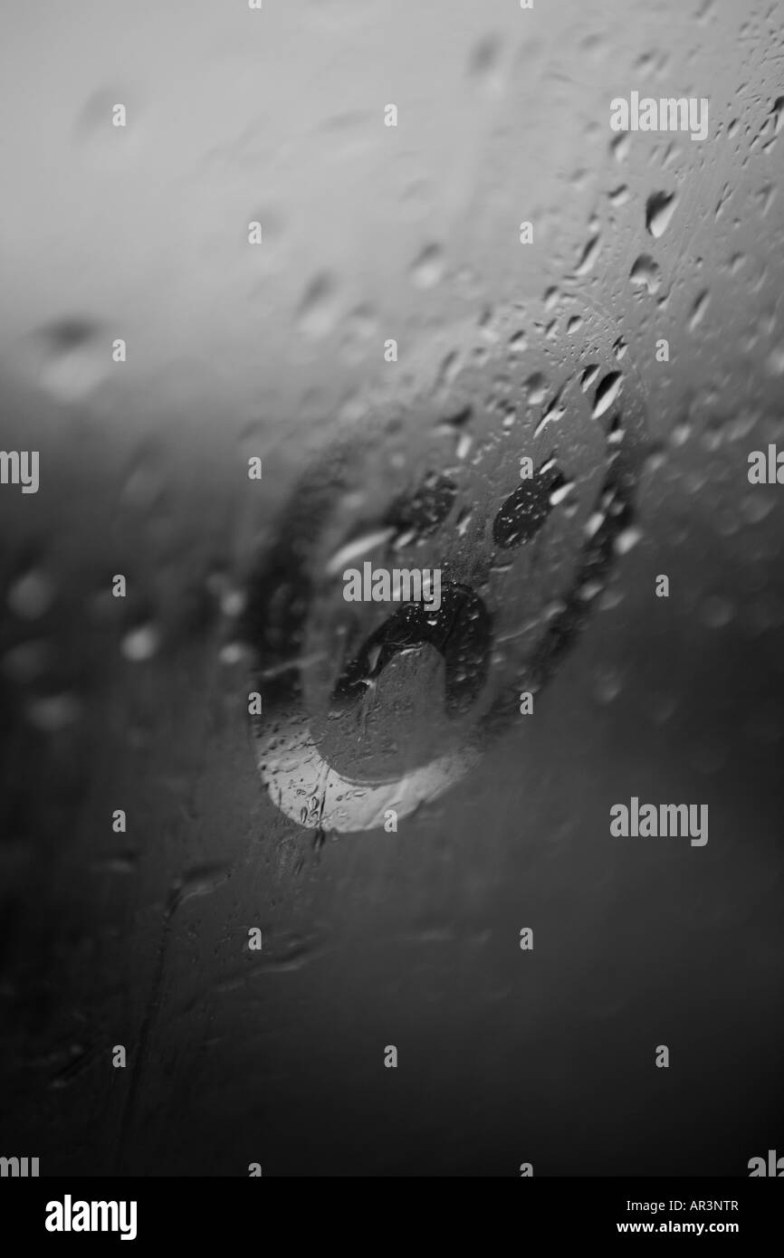Sad face drawn on the condensation on a rainy window Stock Photo - Alamy