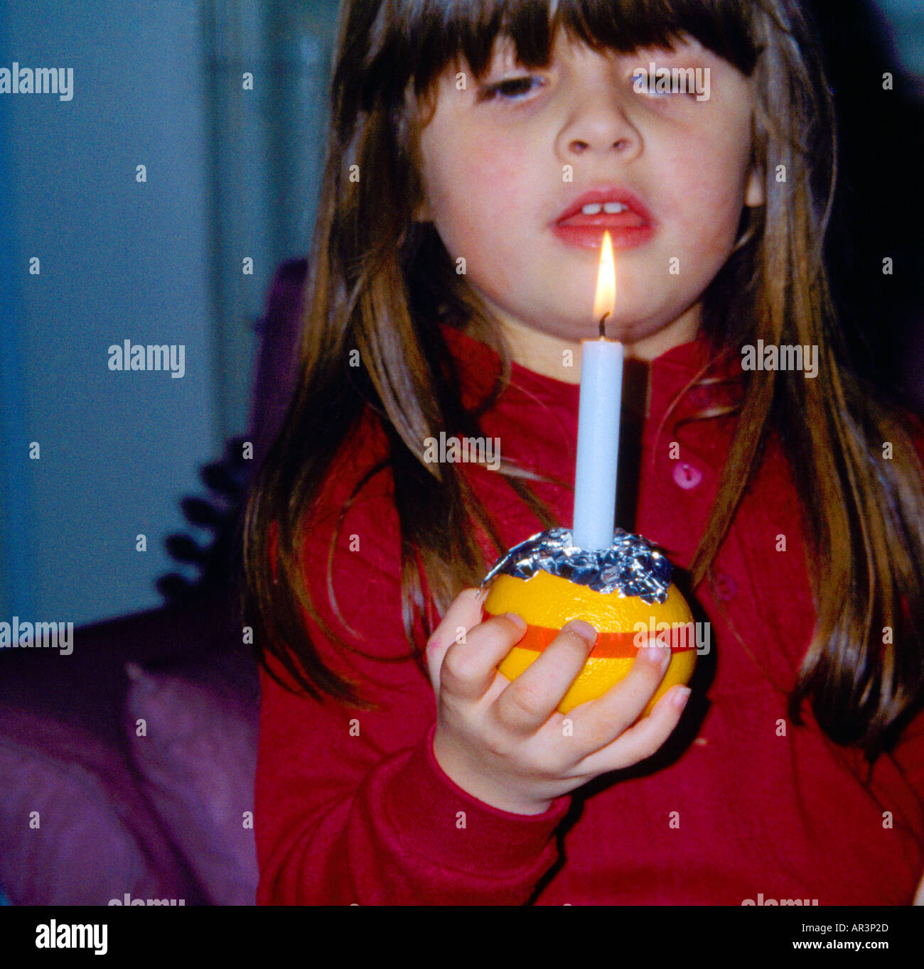 Girl Holding Christingle Candle Stock Photo - Alamy