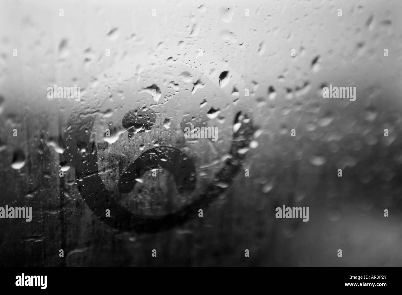 Sad face drawn on the condensation on a rainy window Stock Photo - Alamy