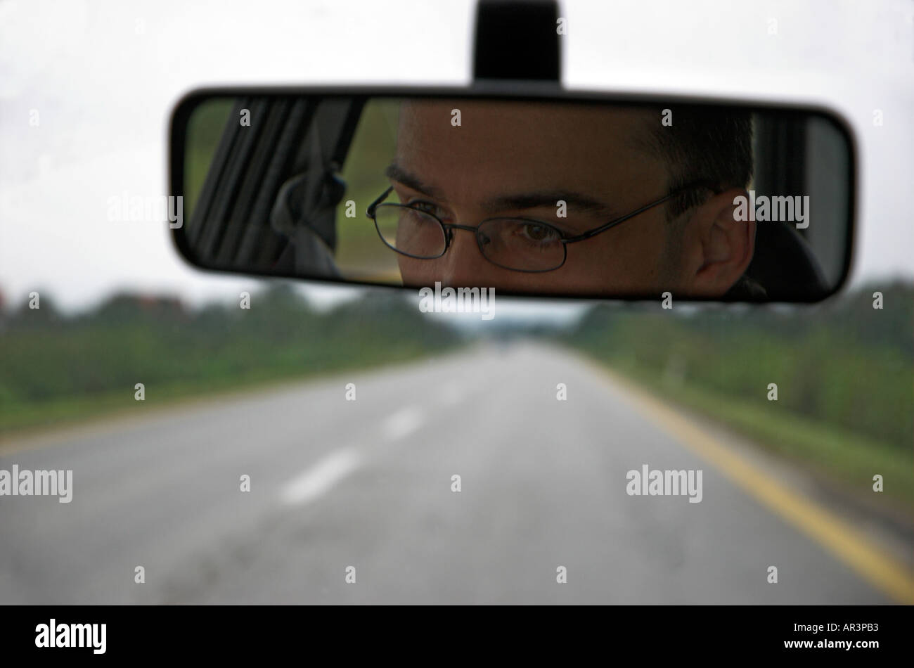 Man's Eyes Reflected In Car Rear View Mirror Stock Photo - Alamy