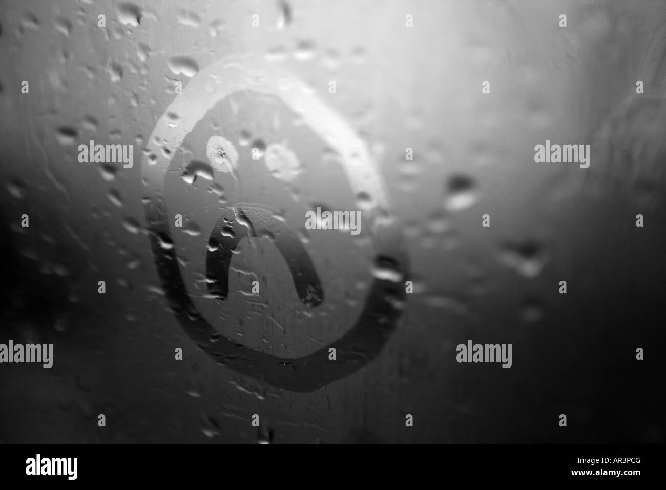 Sad face drawn on the condensation on a rainy window Stock Photo - Alamy
