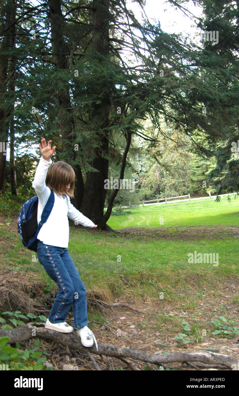 Young girl walking on log, portrait Stock Photo - Alamy