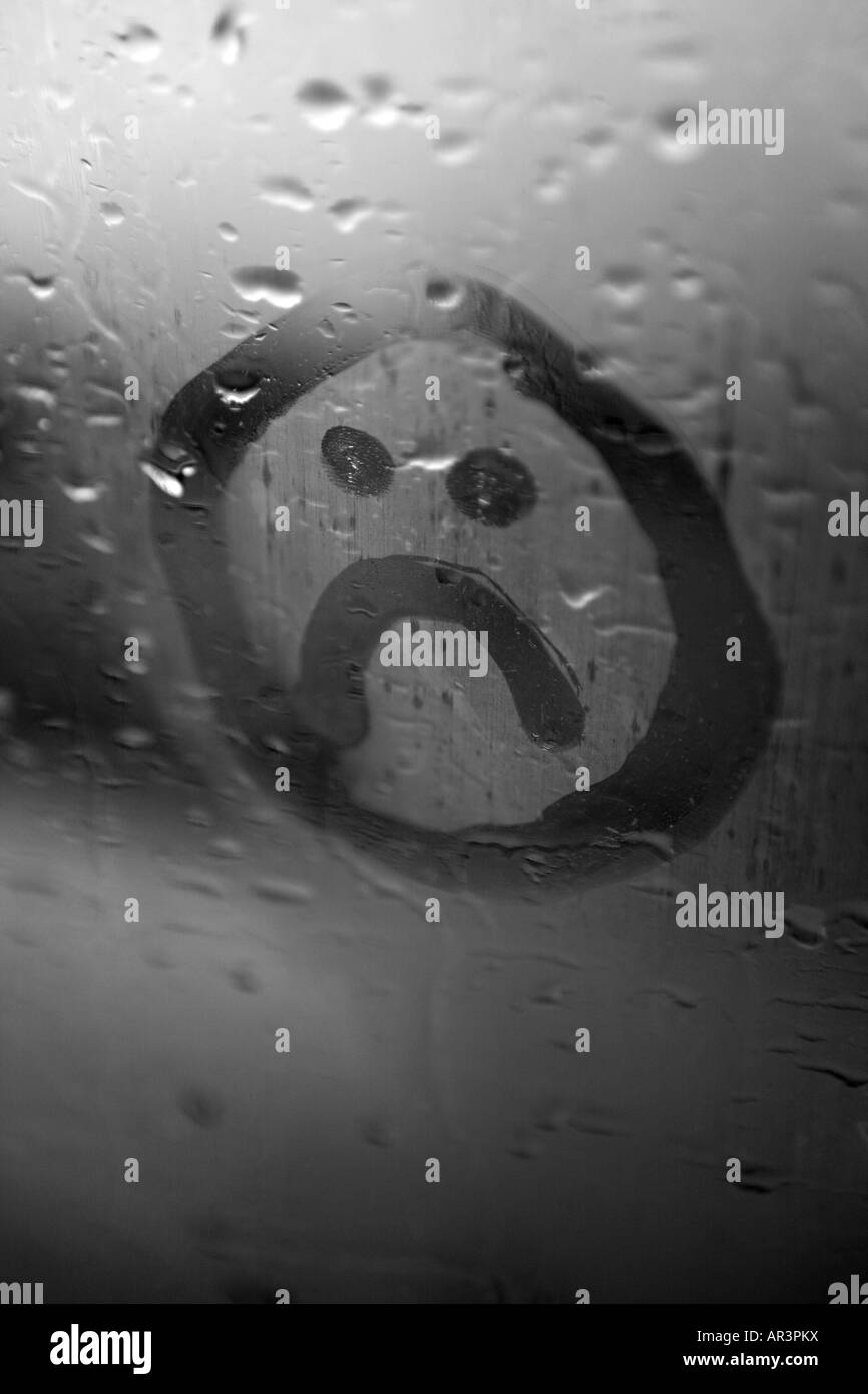 sad face drawn on the condensation on a rainy window Stock Photo - Alamy