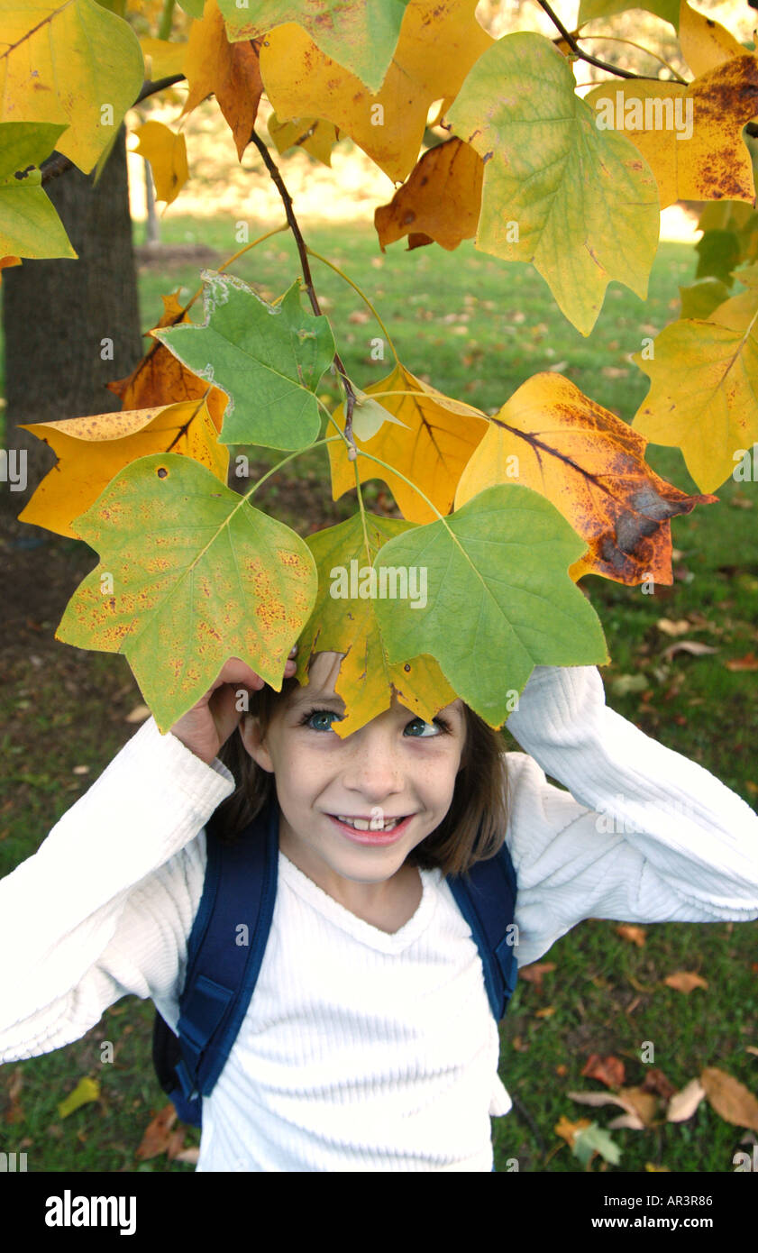 Girl looking out from under leaf, portrait Stock Photo - Alamy