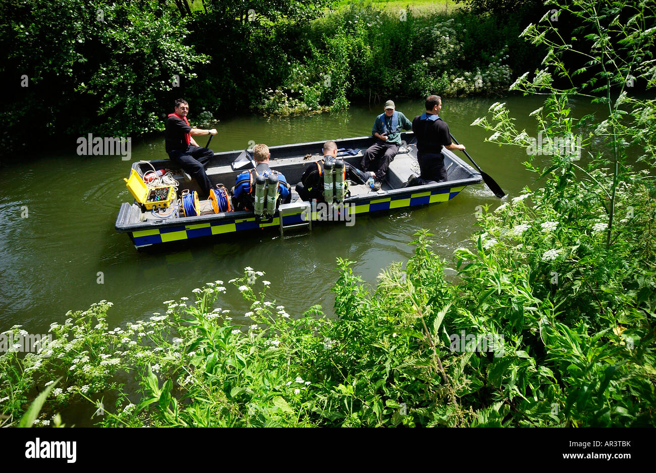 Police diving teams searching river boat stream Stock Photo - Alamy
