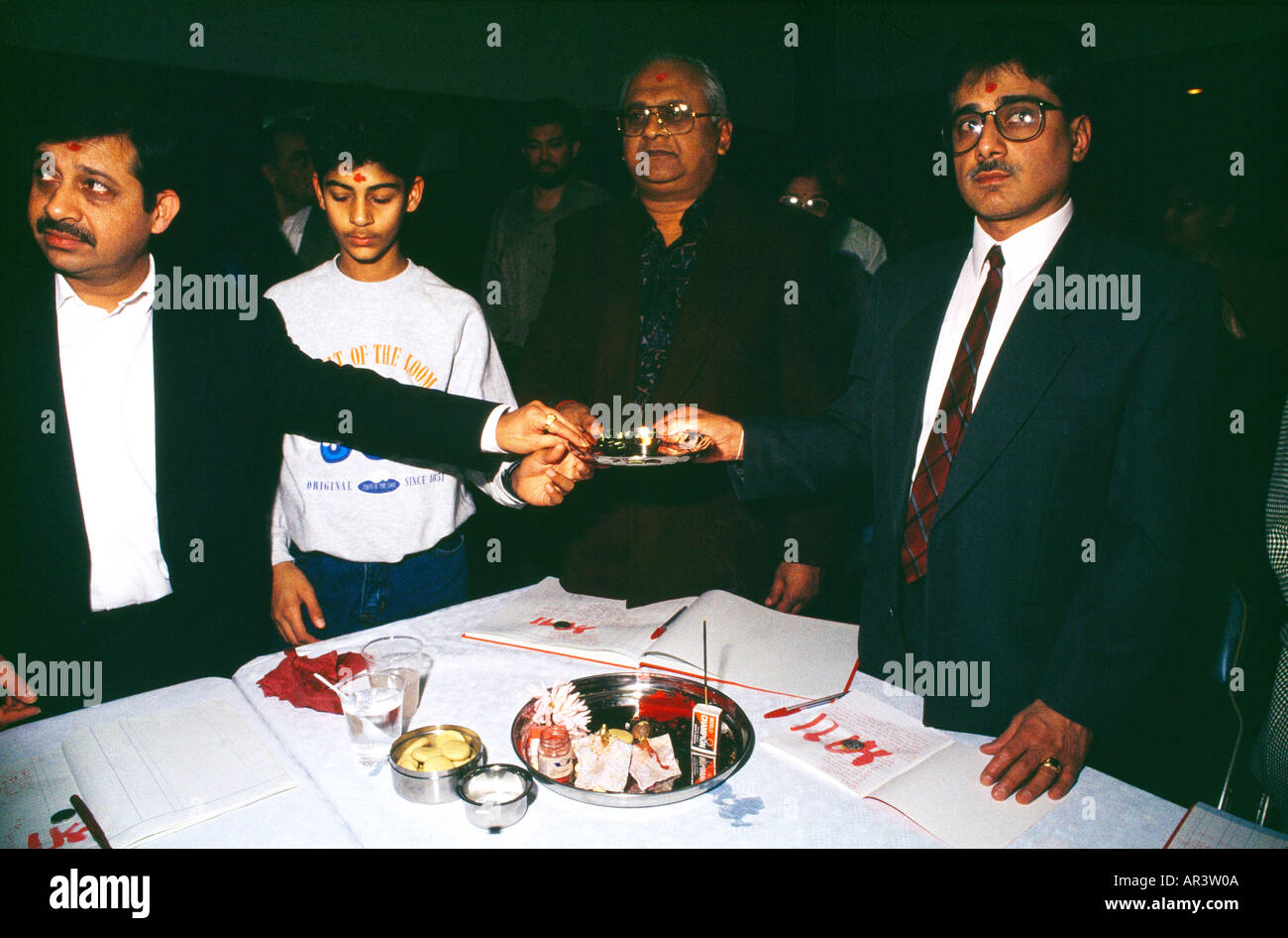 Holding Diya over Red Chopdis Performing Chopda Puja During Diwali ...