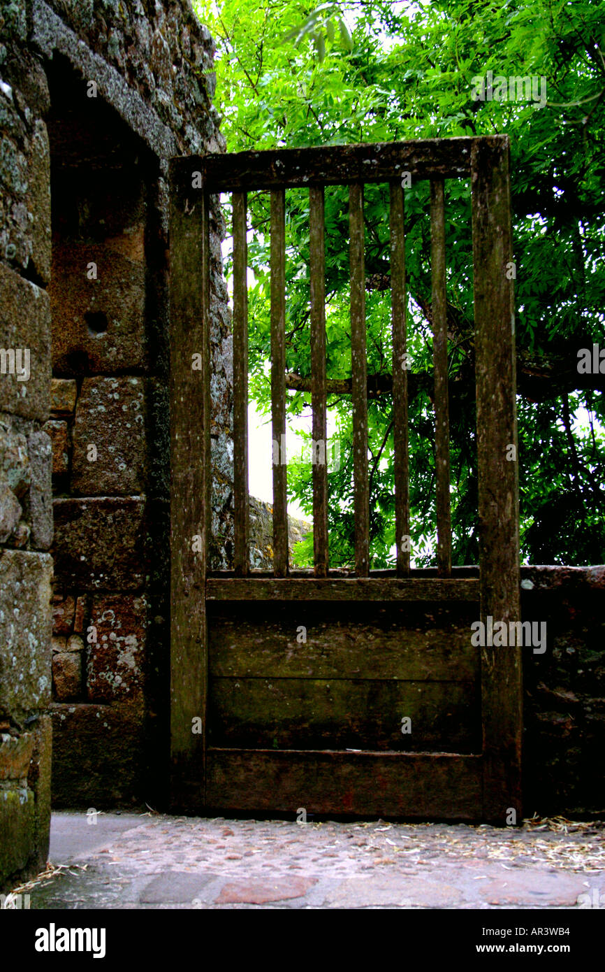 Stone wall with an open gate Stock Photo - Alamy