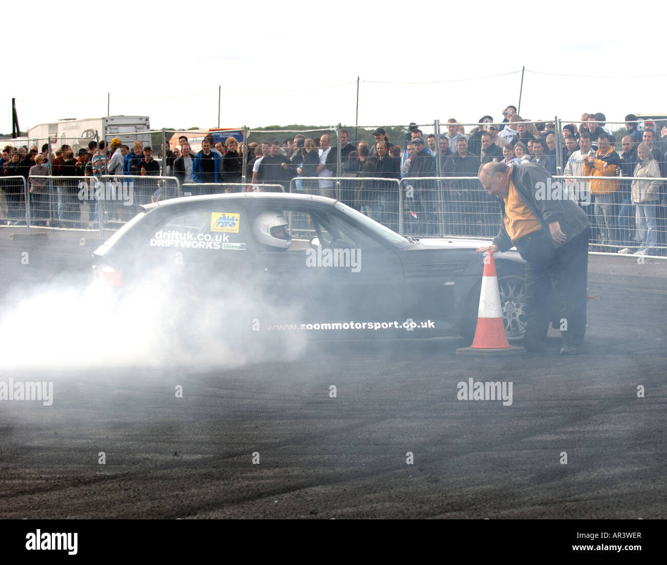 Drifting a rear wheel drive car around a fat man Stock Photo - Alamy