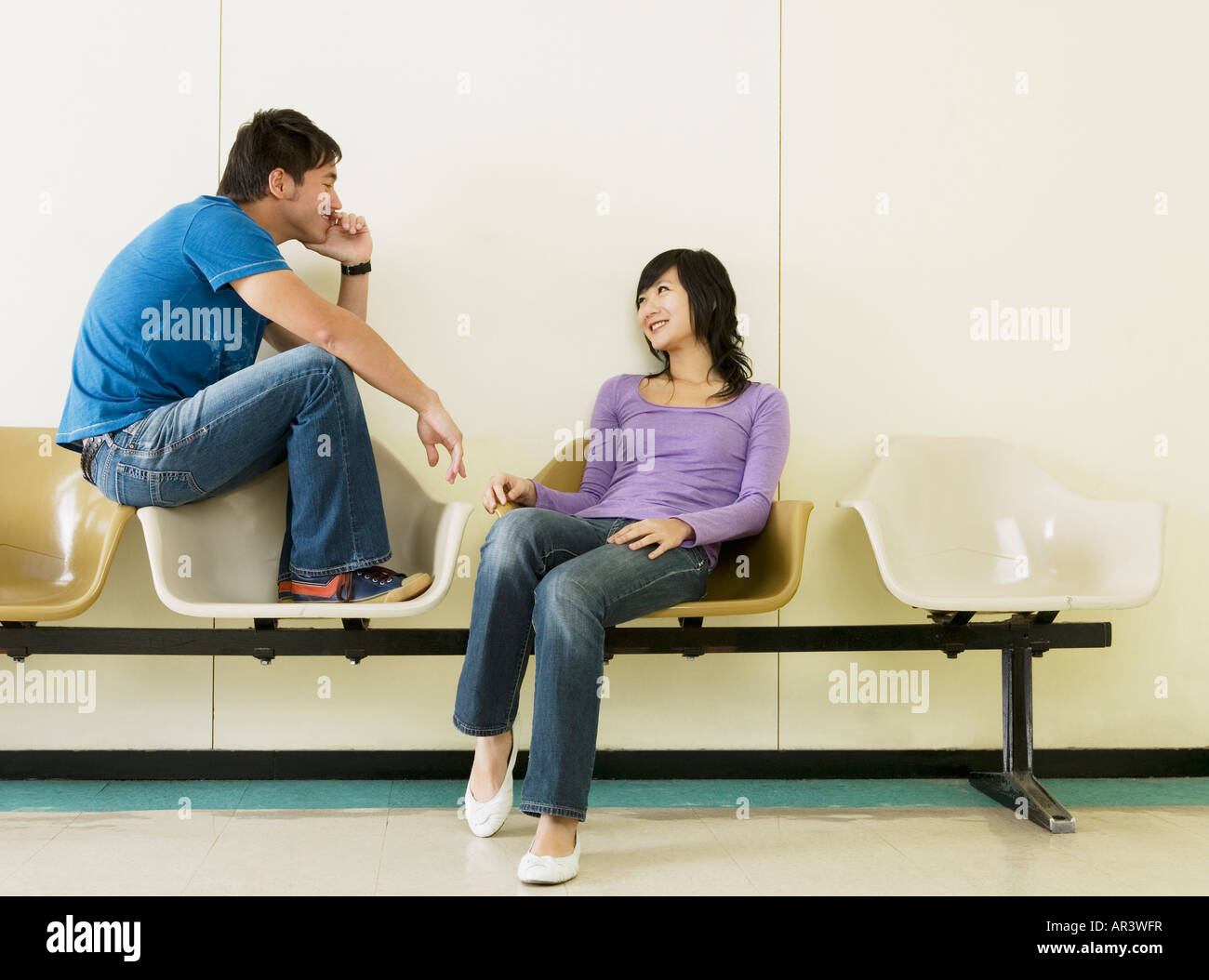 Asian couple smiling at each other Stock Photo - Alamy