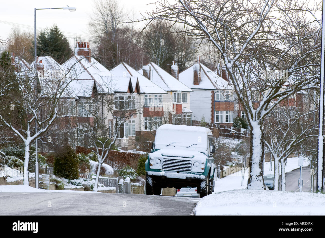 Snow covered Knowle Lane a road in the suburbs of Sheffield England ...