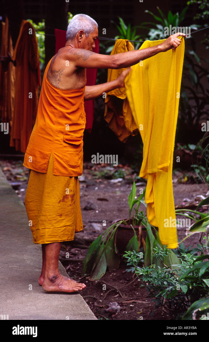 Buddhist monk hanging out his newly washed robes to dry, Thailand Stock ...