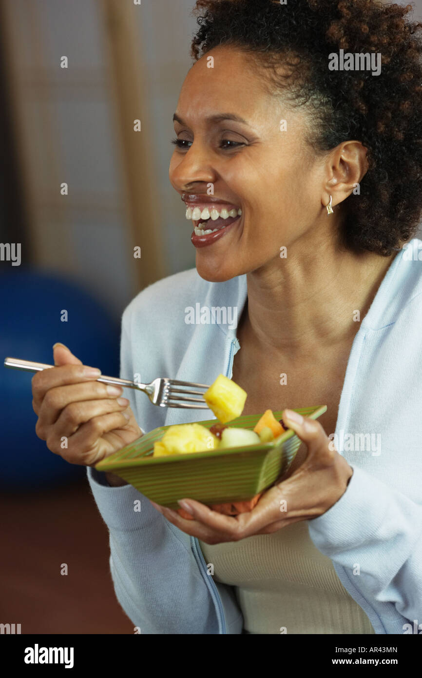African woman eating fruit Stock Photo - Alamy