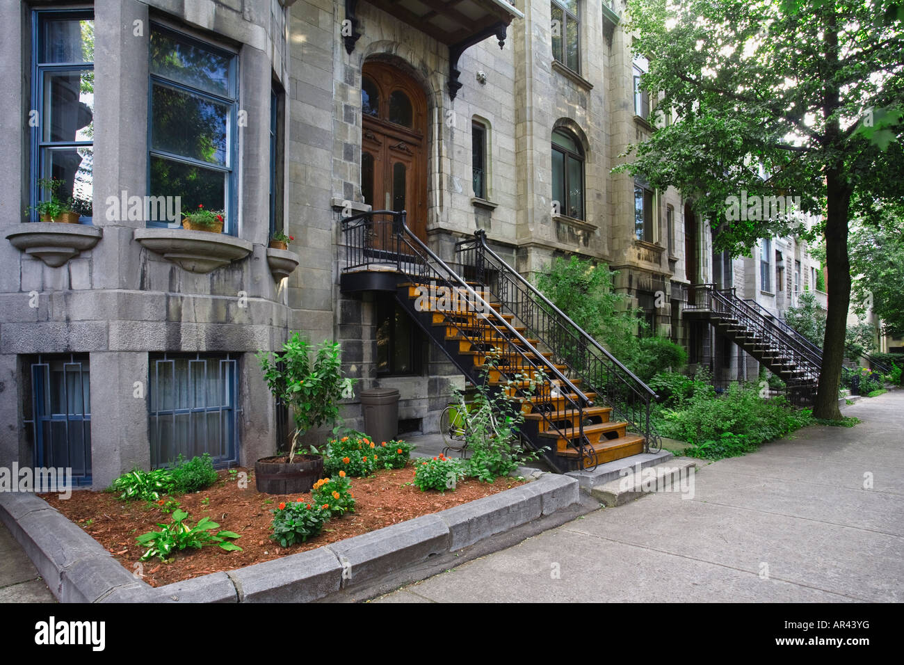 Typical stone homes with their wrought iron railings and entry steps in ...