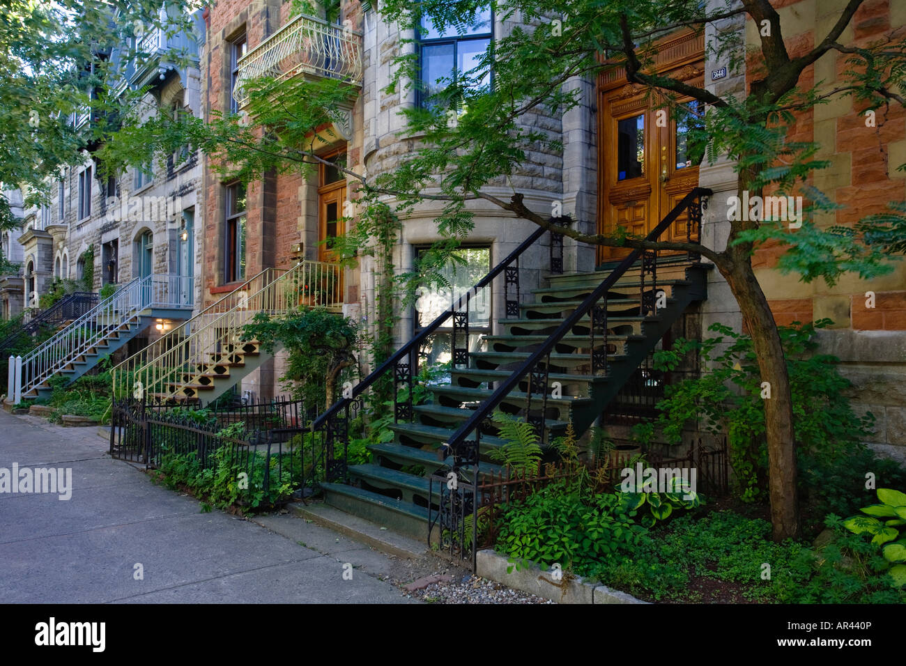 Typical stone homes with their wrought iron railings and entry steps in ...