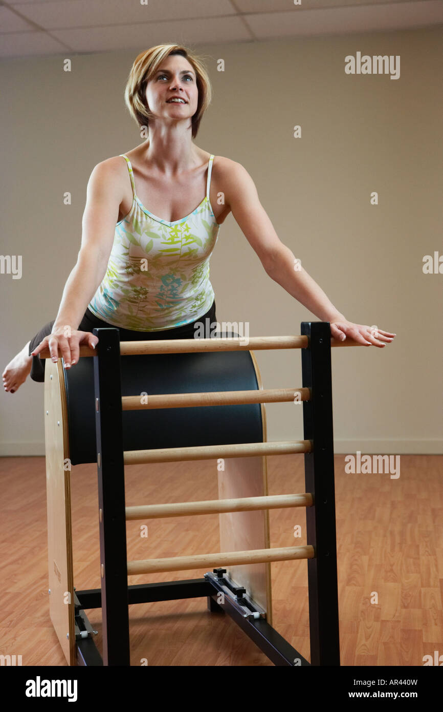Woman exercising on equipment Stock Photo - Alamy