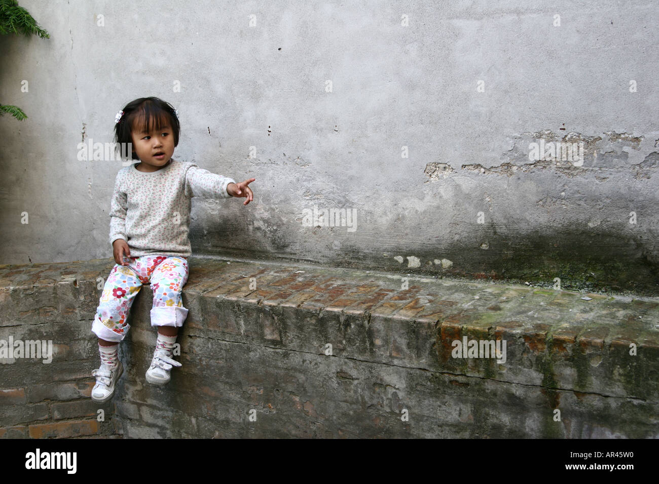 chinese child pointing with fingeron a wall Stock Photo - Alamy