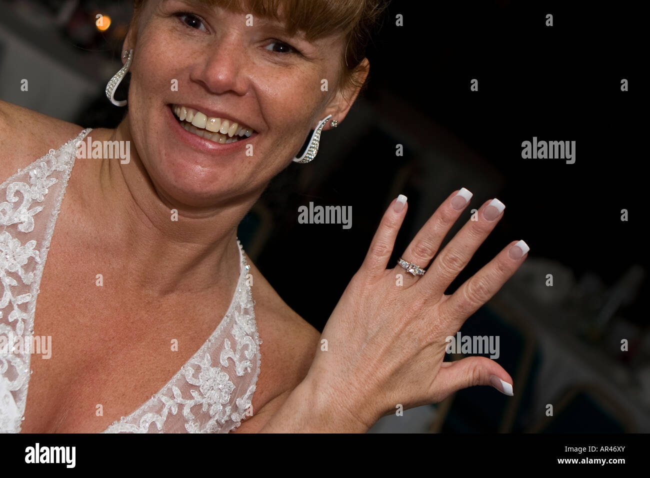 Pretty bride showing off her wedding rings Stock Photo - Alamy