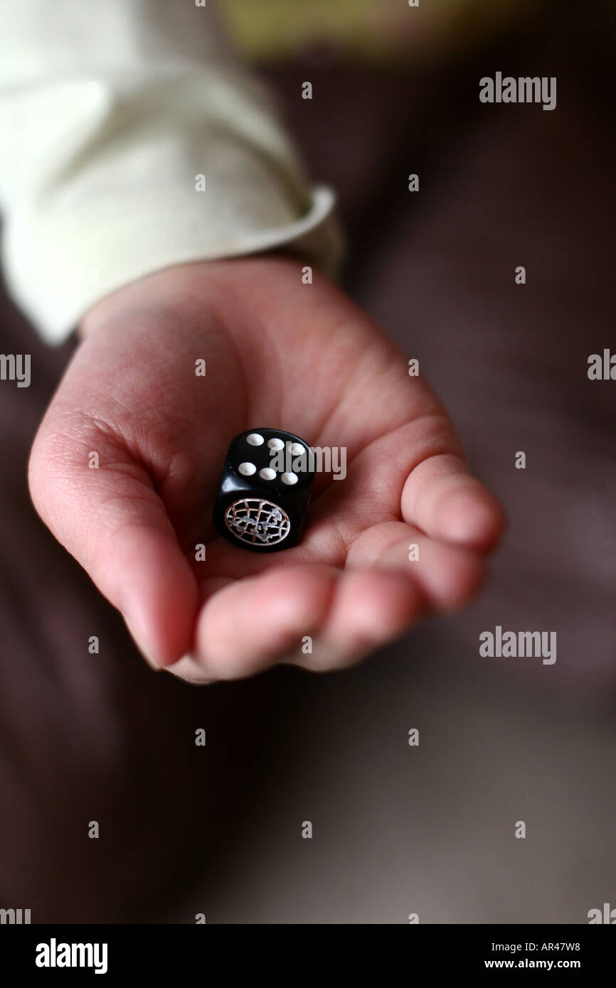 playing indoor game. hand of child holding a dice Stock Photo - Alamy
