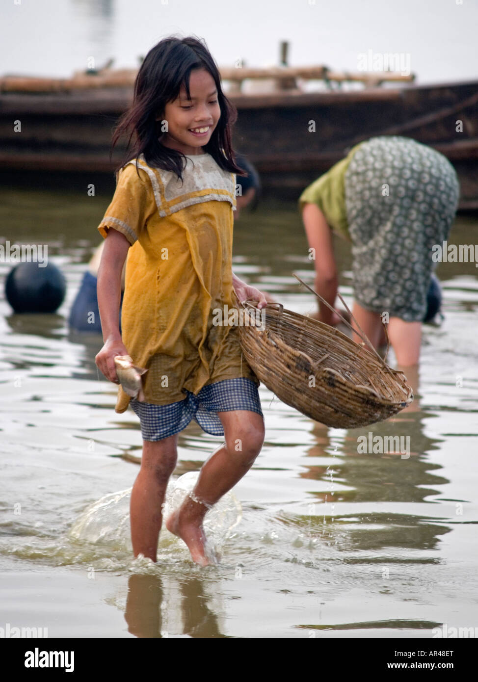 smiling Burmese girl looking for fish Stock Photo - Alamy