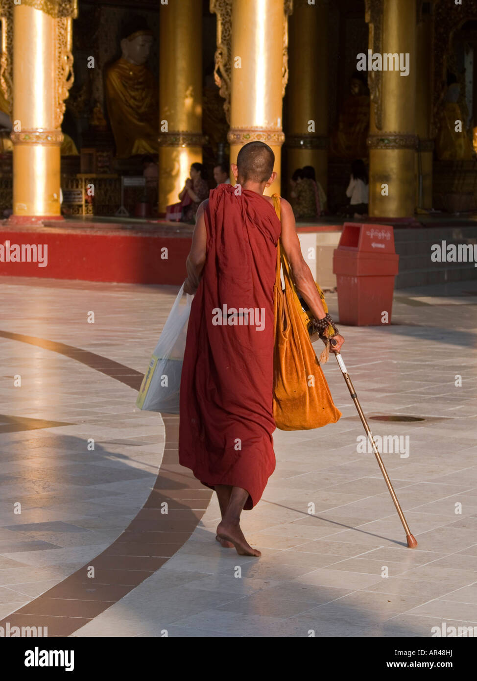 a monk and his cane walking at Shwedagon Paya Burma s most famous ...