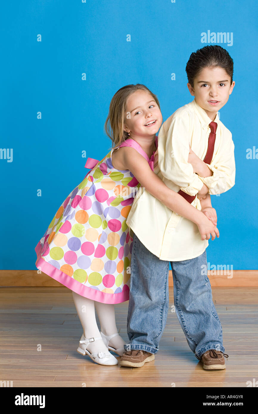 Girl trying to hug boy Stock Photo - Alamy