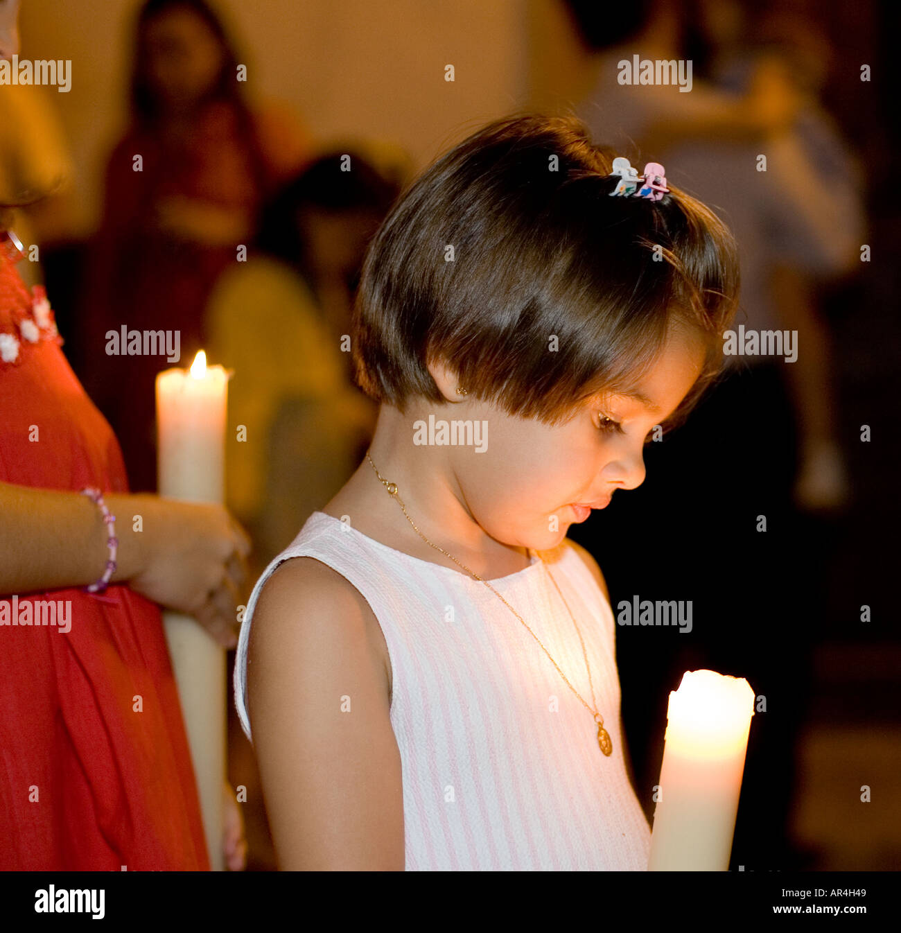 Little girl with a candle during a Catholic procession Stock Photo - Alamy