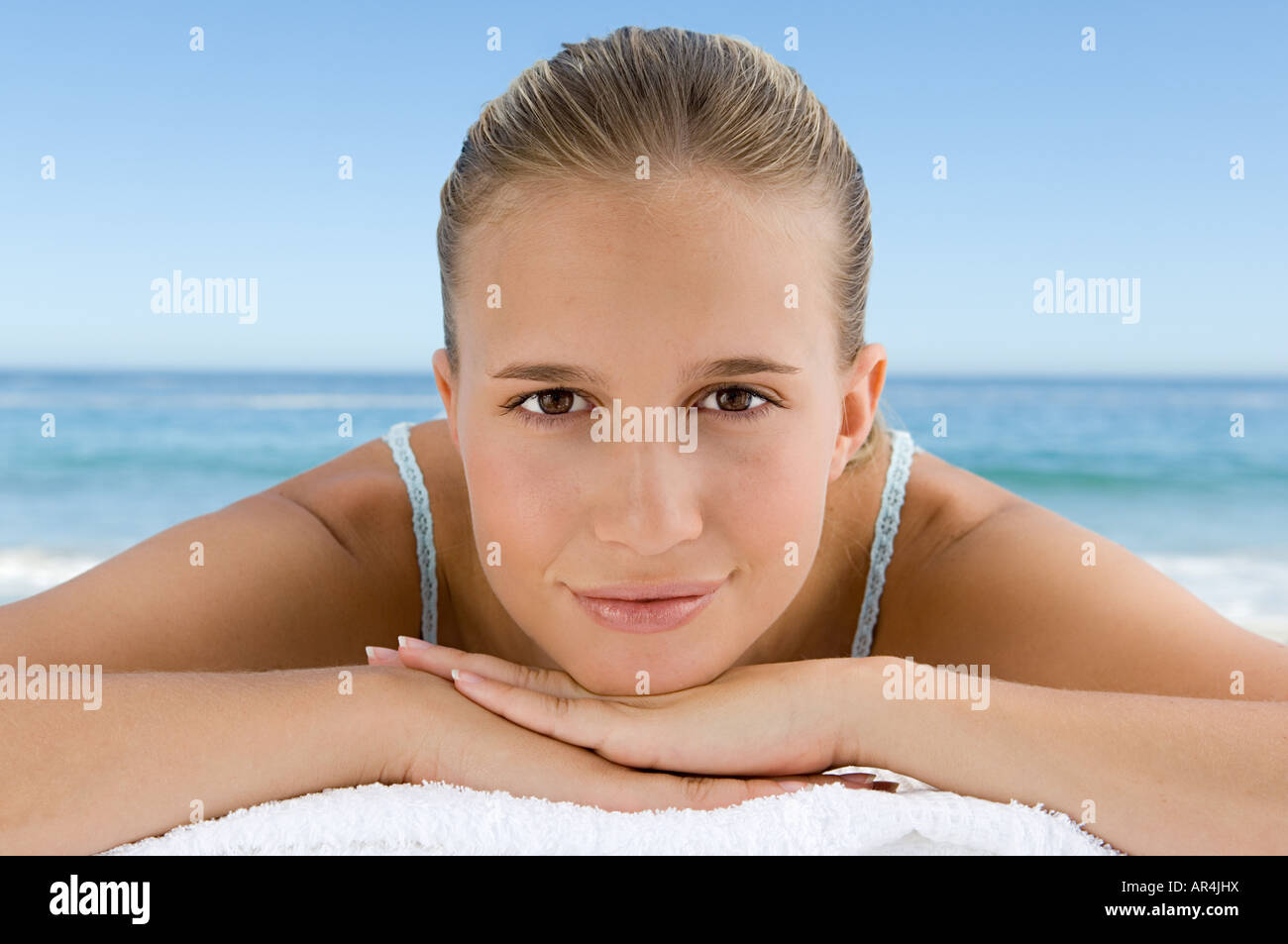 Young woman relaxing on a beach Stock Photo - Alamy