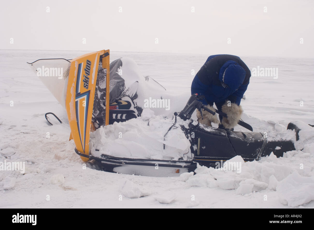 inupiat guide Bruce Inglangasak about to clear snow built up in his ...